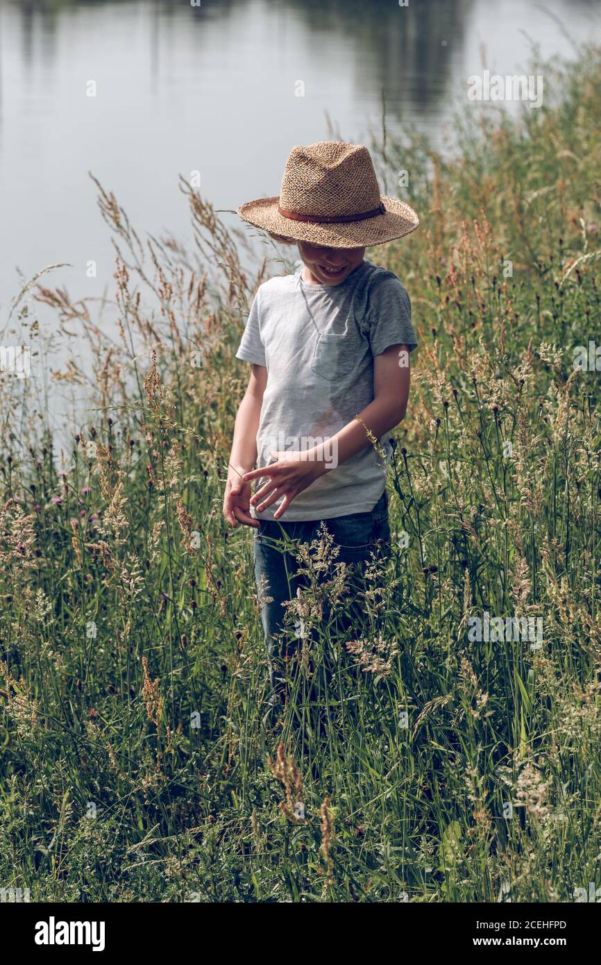 Little boy standing near water Stock Photo - Alamy