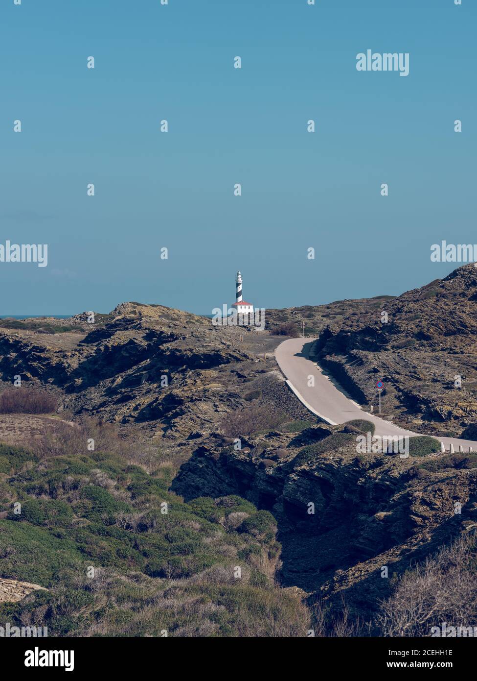 View to lighthouse tower and road in the mountains in Menorca Stock ...