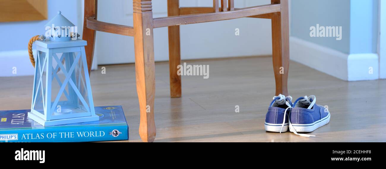 Atlas Blue Lantern Deck shoes and wooden chair Stock Photo - Alamy