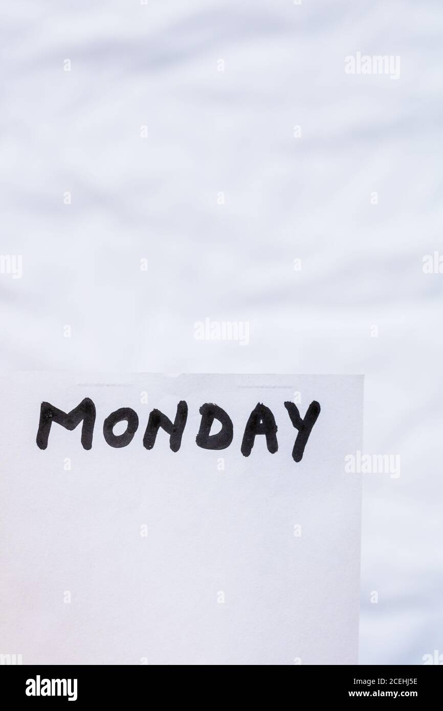 Monday handwriting text close up isolated on white paper with copy ...