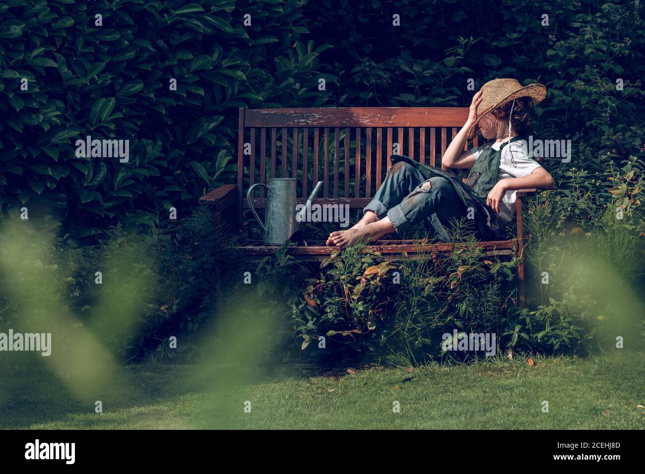 Sleepy boy taking rest on bench Stock Photo - Alamy
