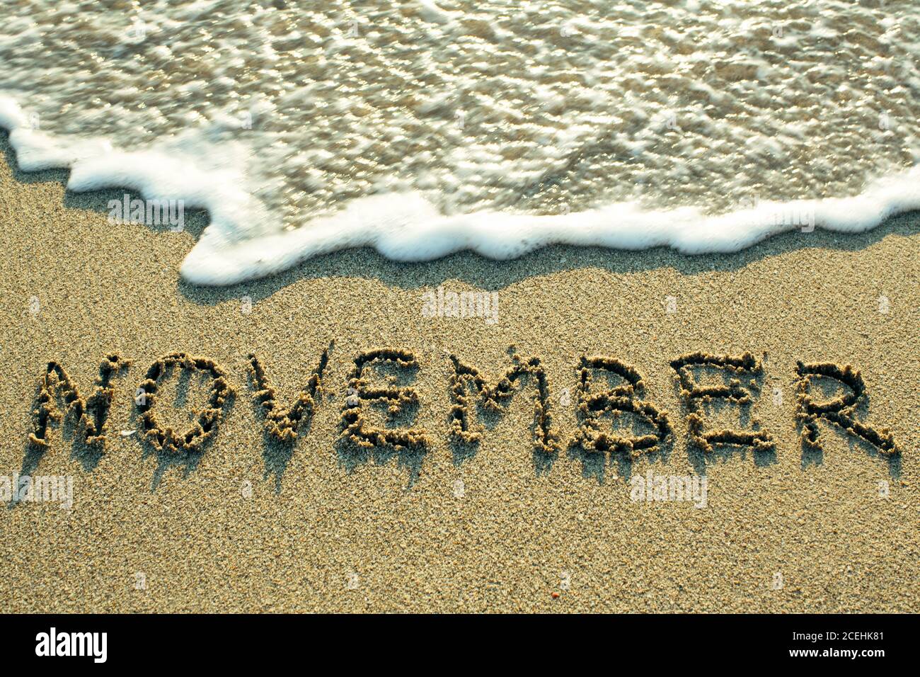 November inscription on the sand beach with the soft wave Stock Photo ...