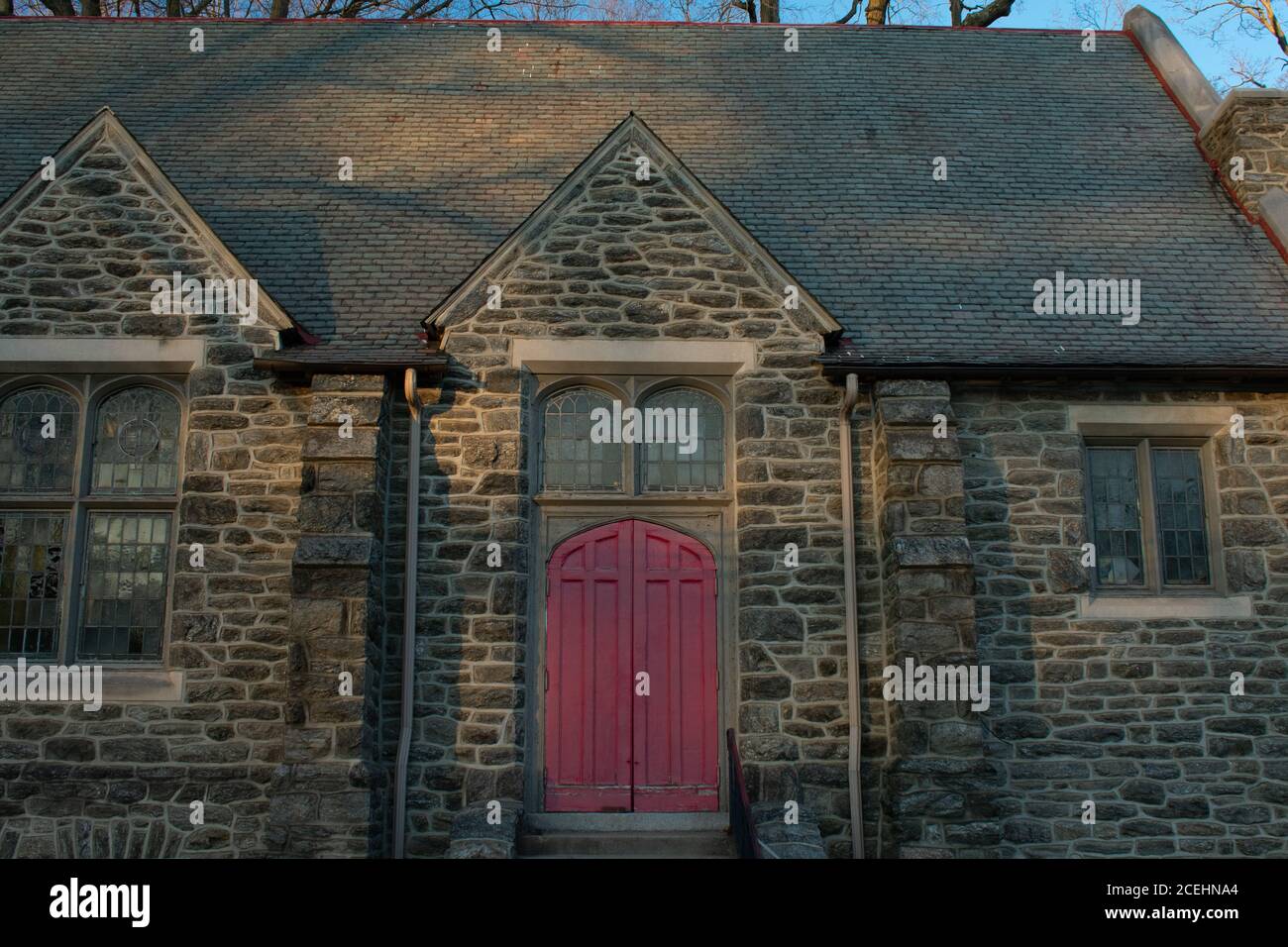 A Bright Red Door in a Cobblestone Church Wall With Steps Leading Up to ...