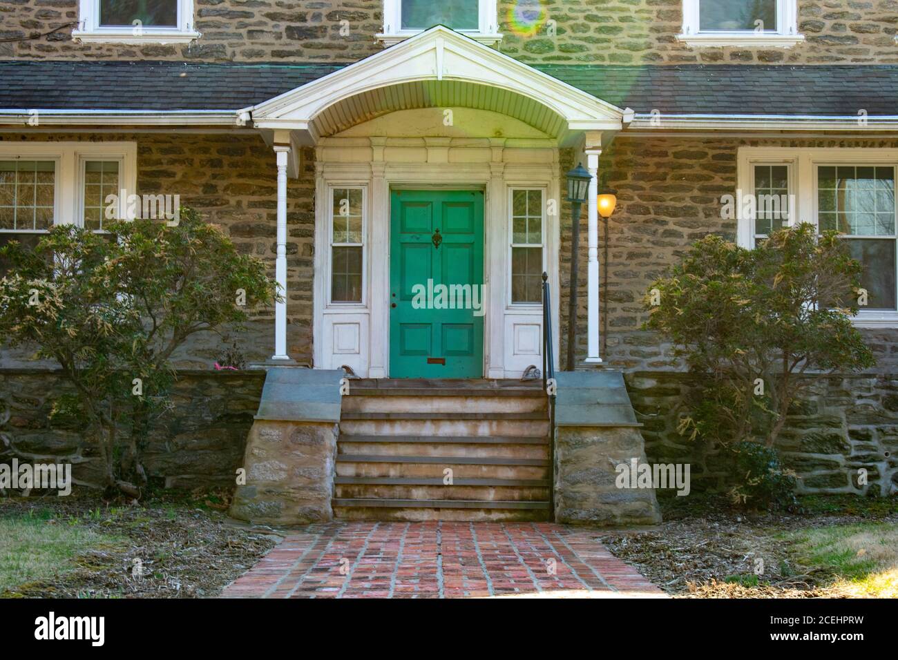A Teal Front Door on a Suburban Home With a Brick Path Leading Up to It ...