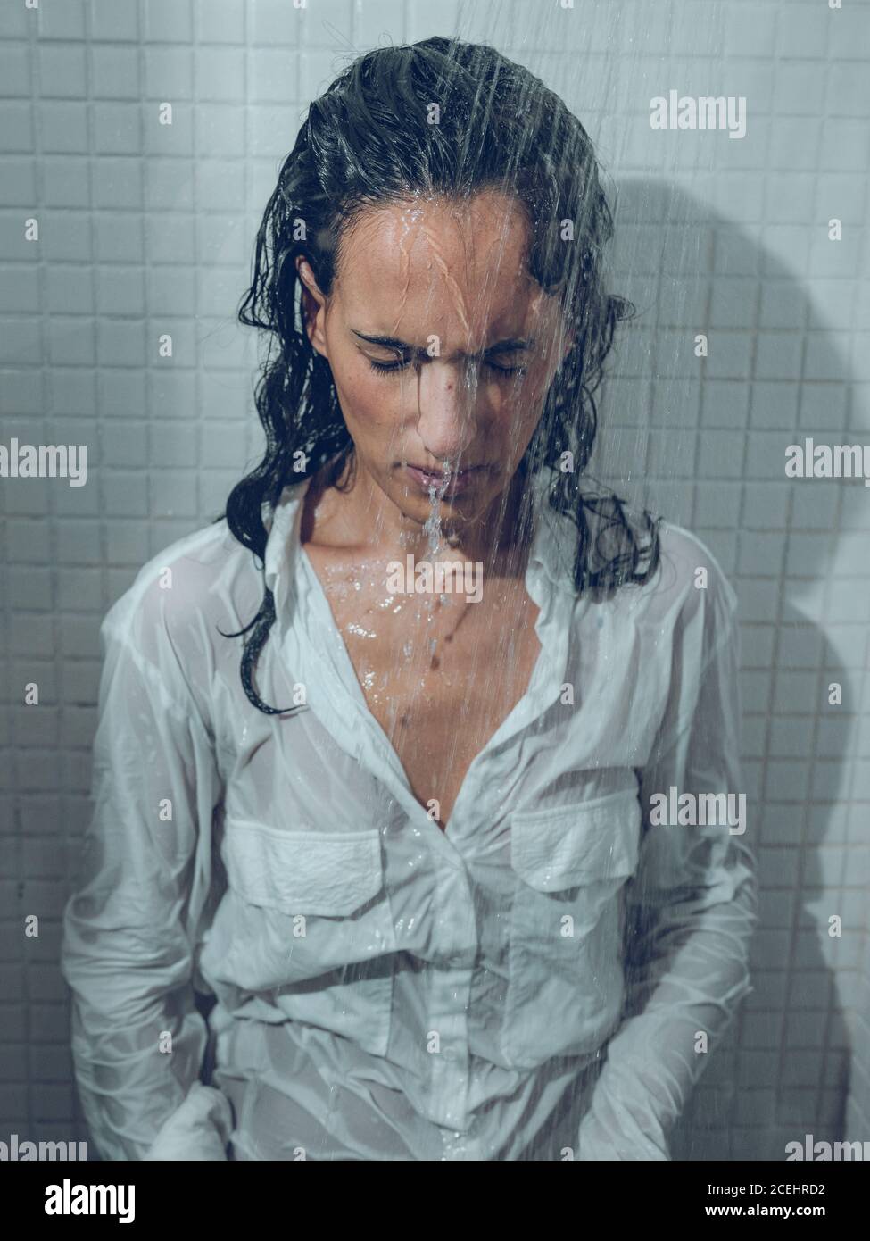Woman dressed wet in the shower Stock Photo - Alamy