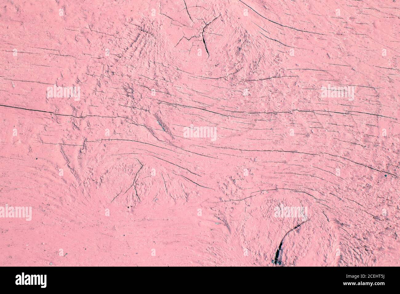 Cracking and peeling pink paint on a wall. Vintage wood background with ...
