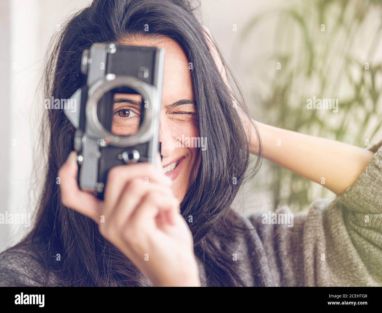 Woman holding camera without lens Stock Photo - Alamy
