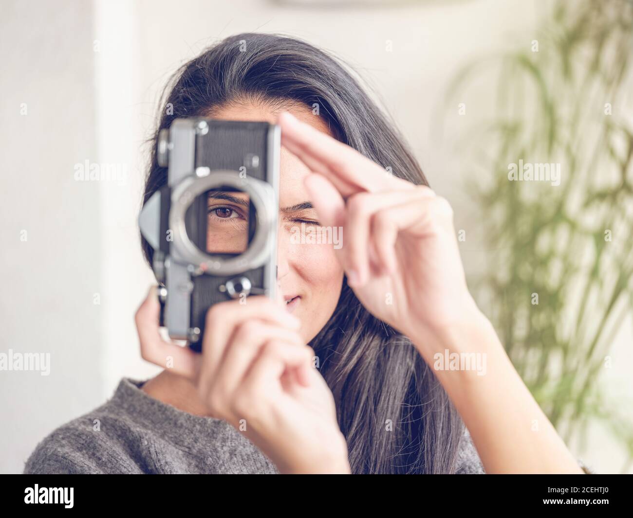 Woman holding camera without lens Stock Photo - Alamy
