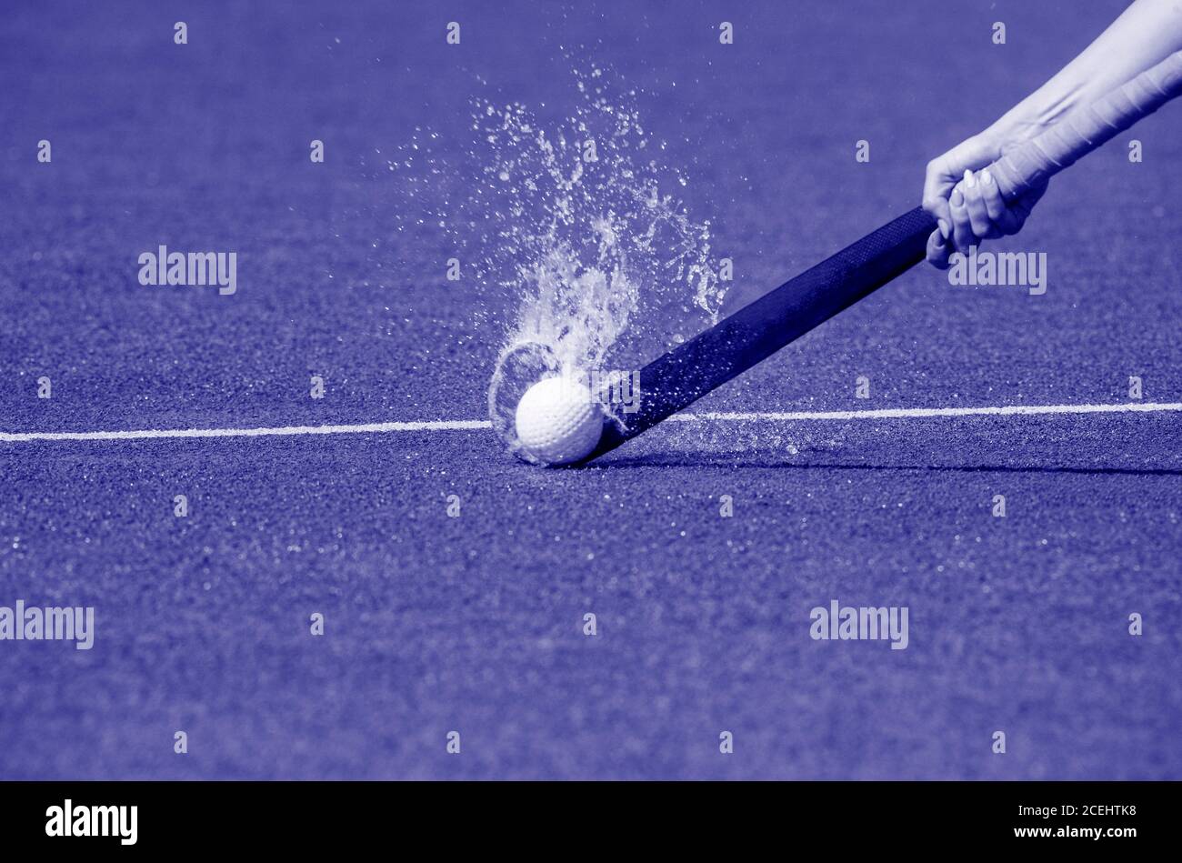 Hockey player with ball in attack playing field hockey game. Blue color ...