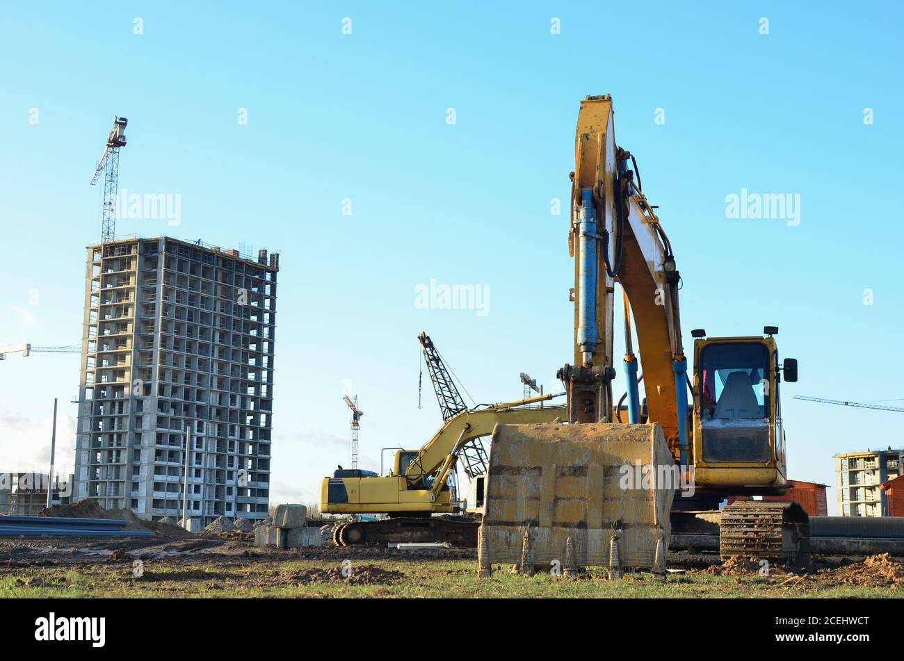 Excavator digs ground at a construction site for installing concrete ...