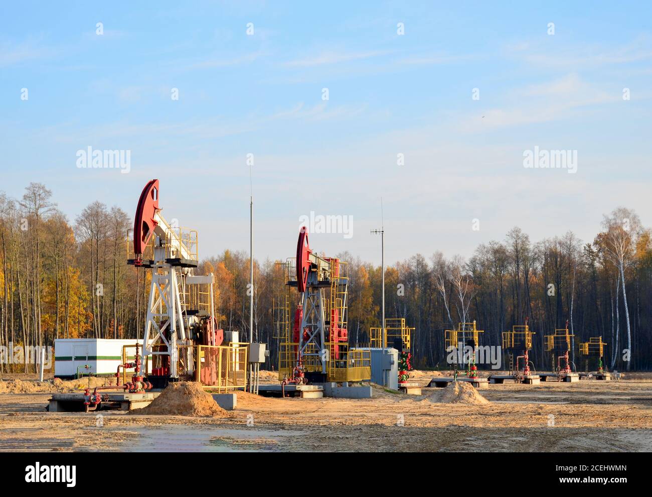 Oil drilling derricks at desert oilfield for fossil fuels output and ...