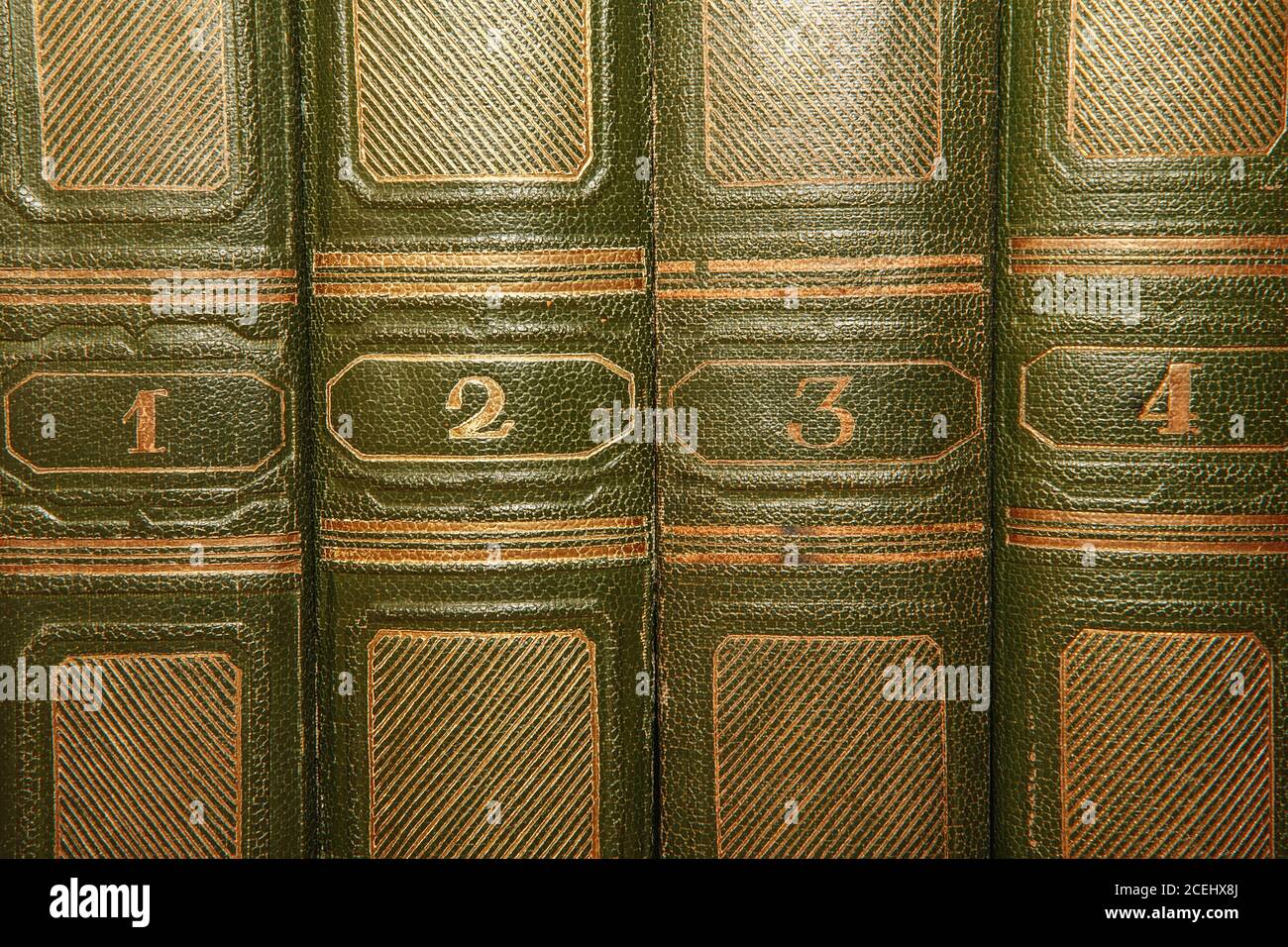 Volumes of old books with gold lettering on the green cover Stock Photo ...