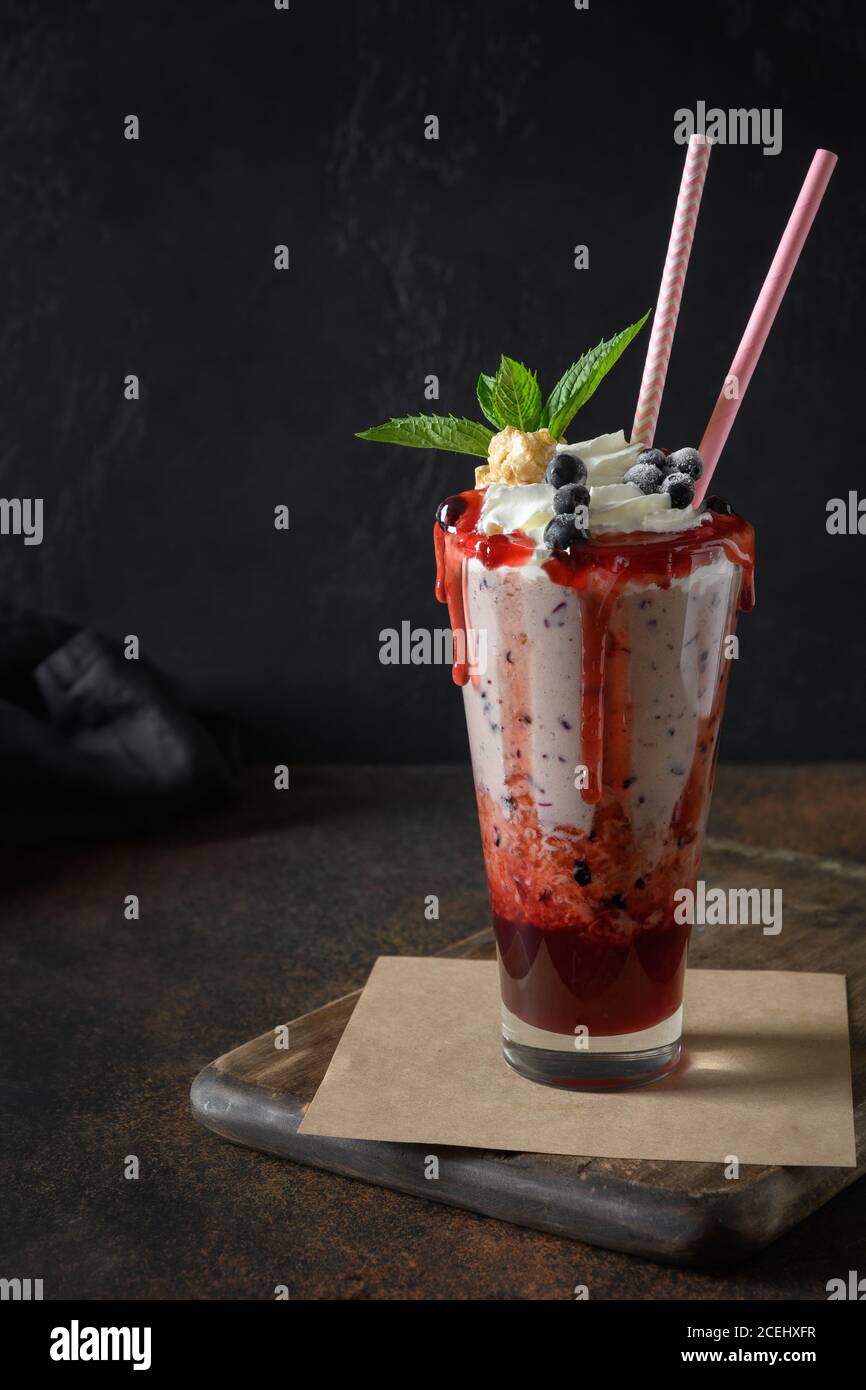 Delicious berry milkshake garnished with whipped cream, blueberries ...