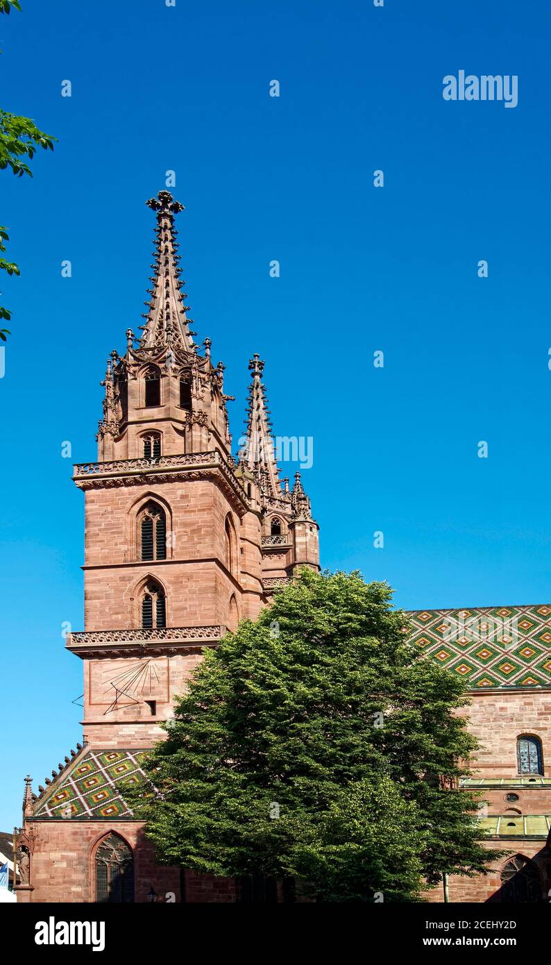 Basel Minster; red sandstone, ornate tower; steeple; colorful tile roof ...