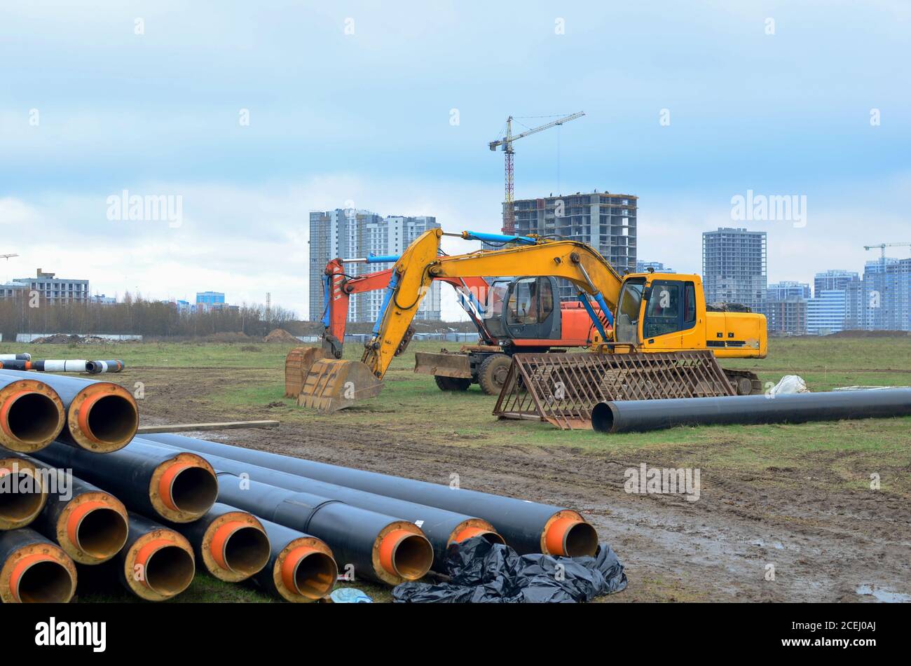 Excavators working at a construction site during laying or replacement ...