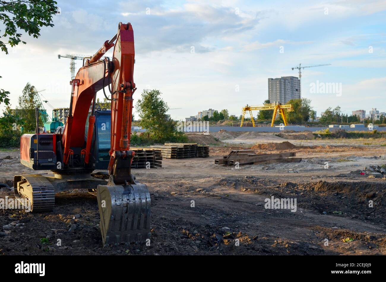 Excavator working at a construction site. Backhoe dig the ground for ...