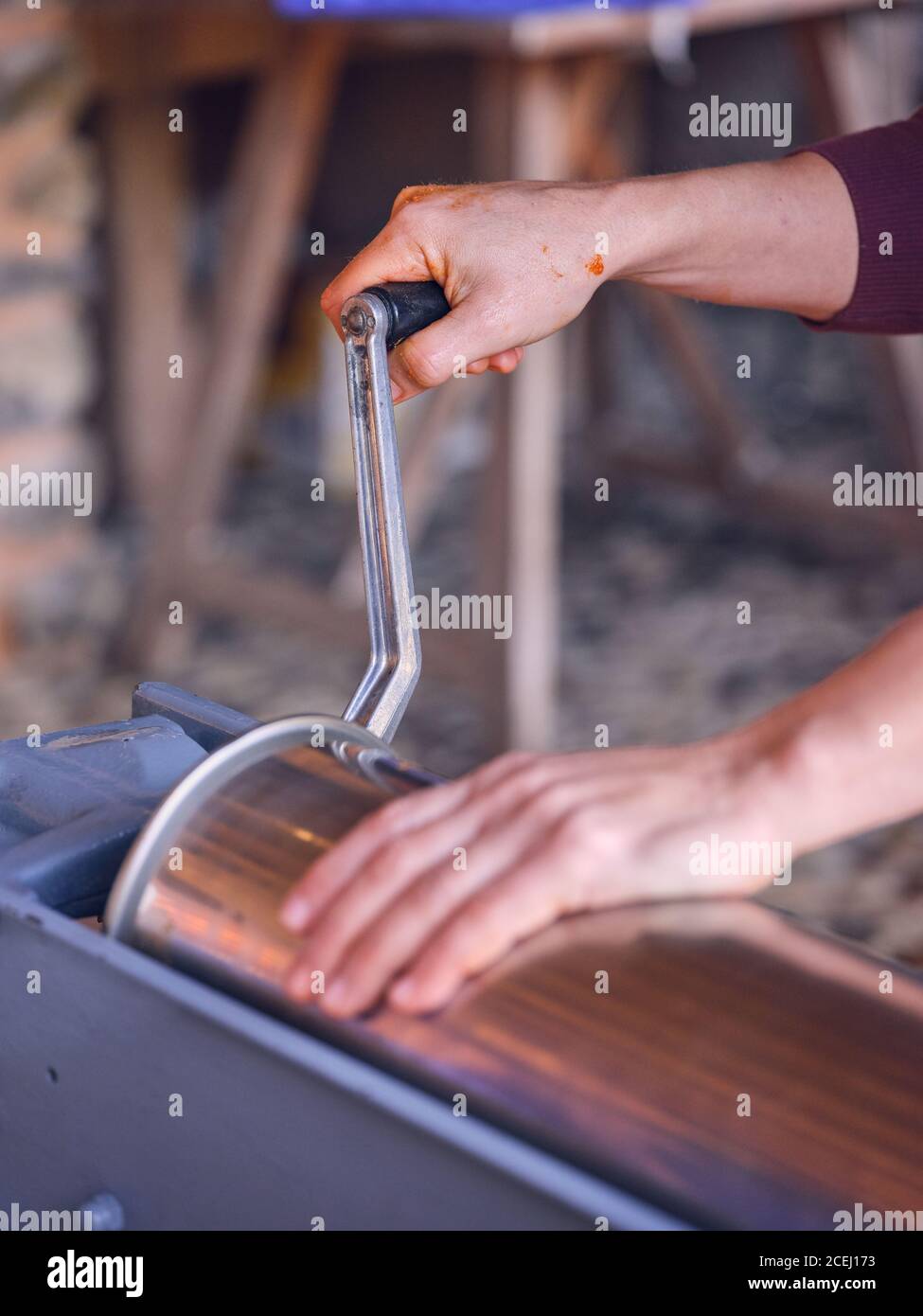 Crop hands of anonymous adult Woman turning handle of metal mincing ...