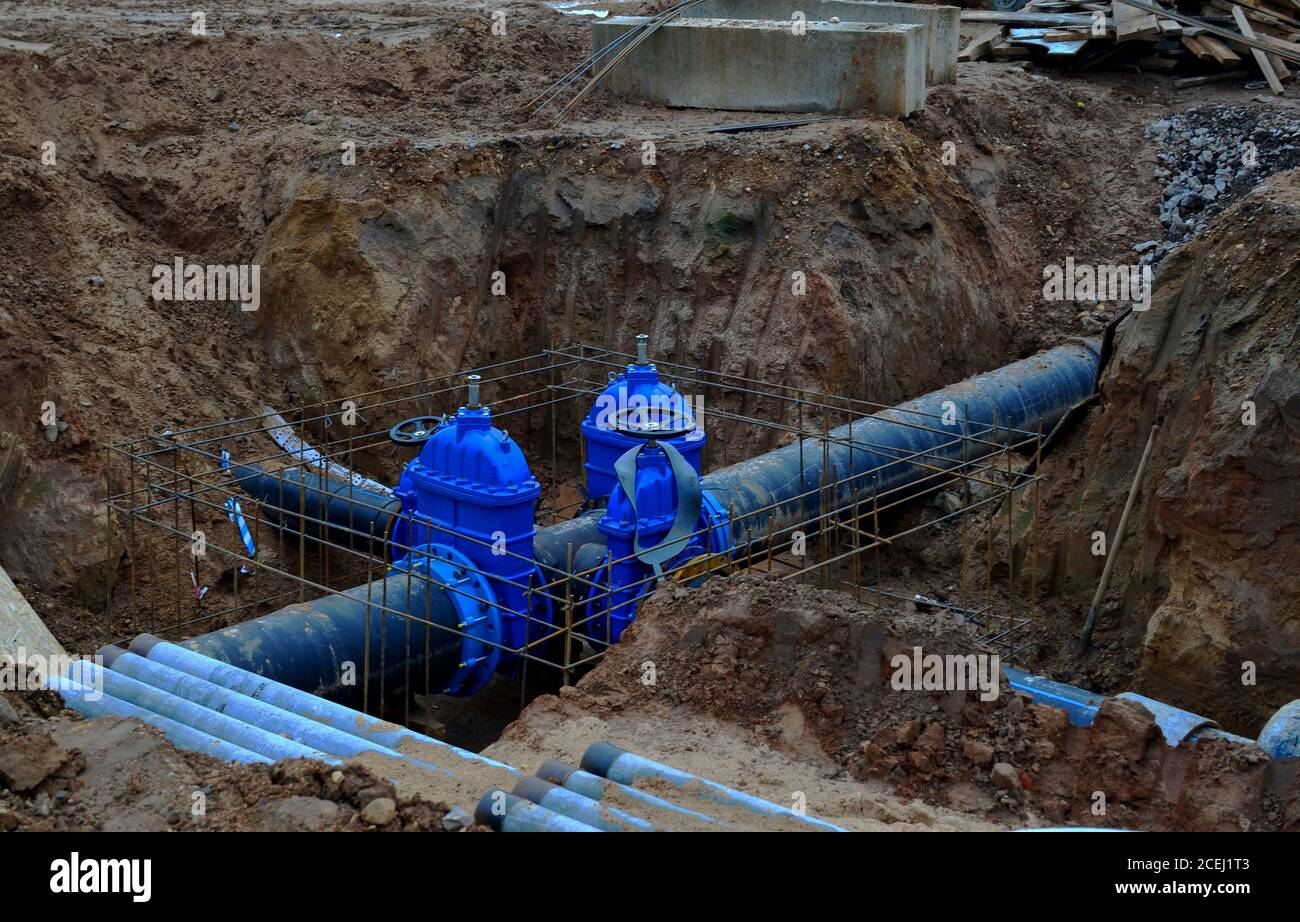 Laying underground storm sewers at construction site, water main ...