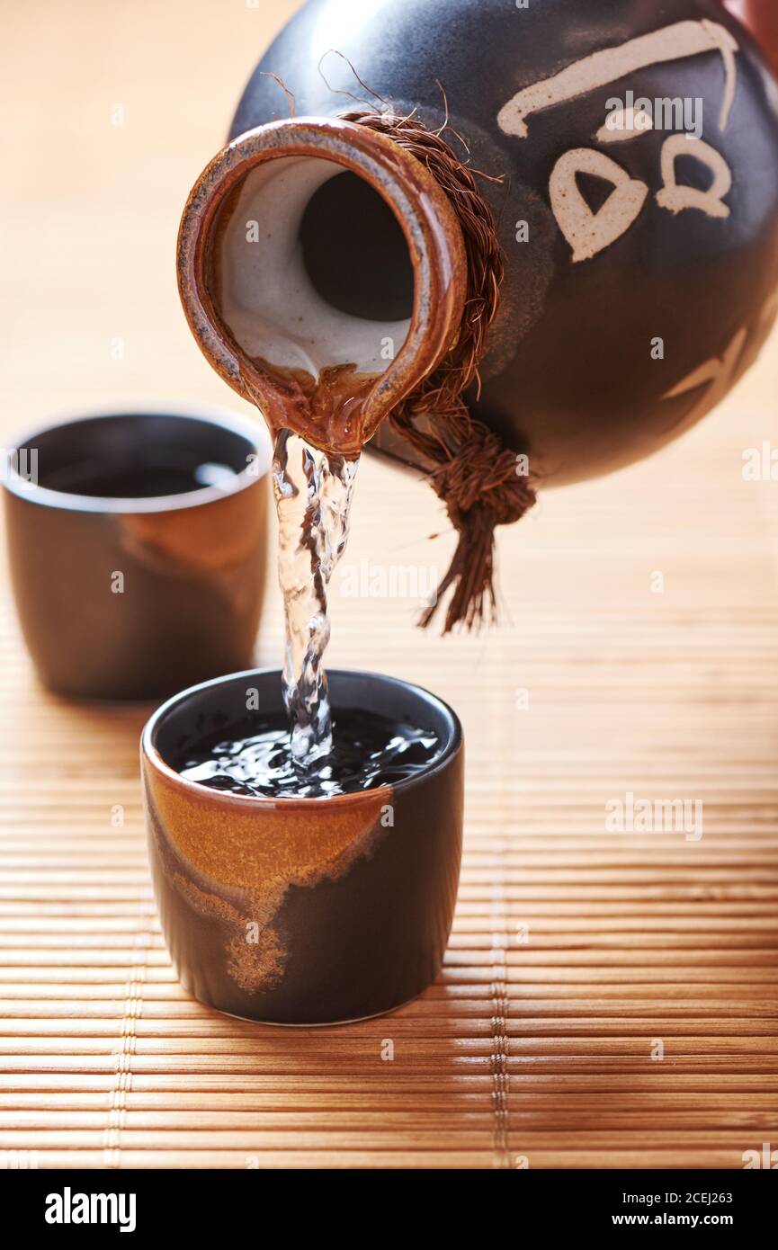Japanese Sake set from a bottle and two shot glasses Stock Photo - Alamy