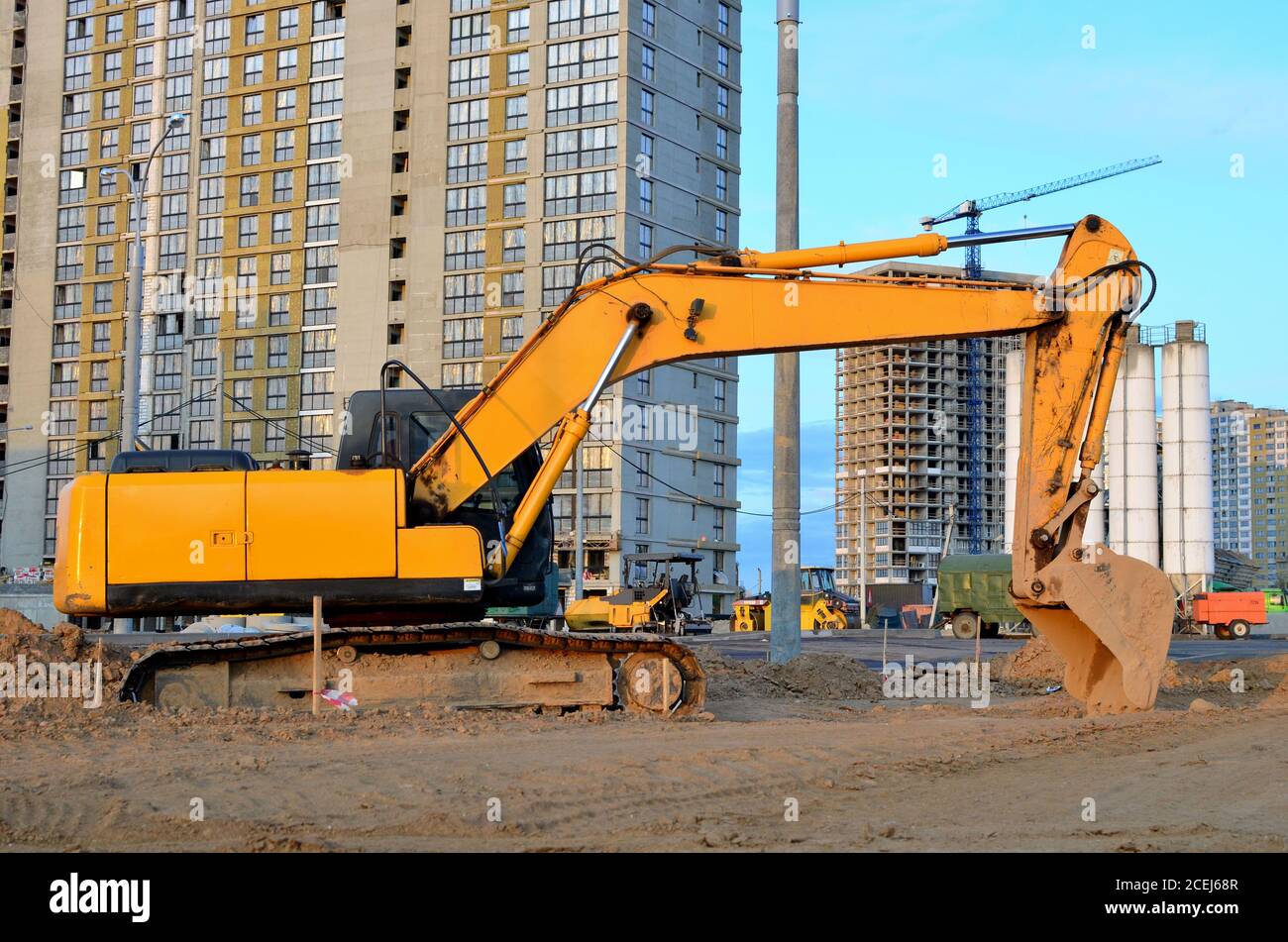 Excavator working at a construction site. Backhoe dig the ground for ...