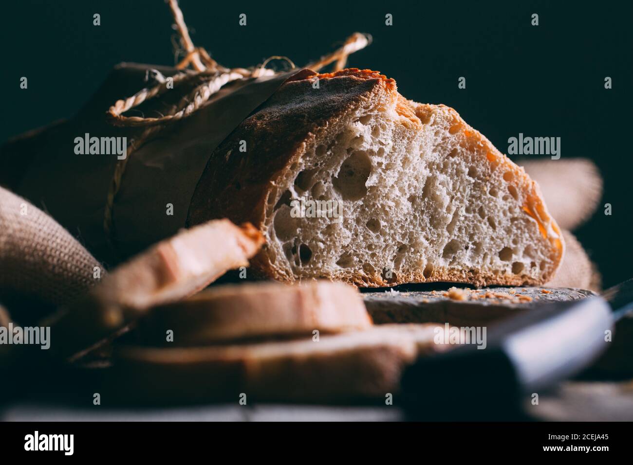 Rustic bread loaf on dark background Stock Photo - Alamy