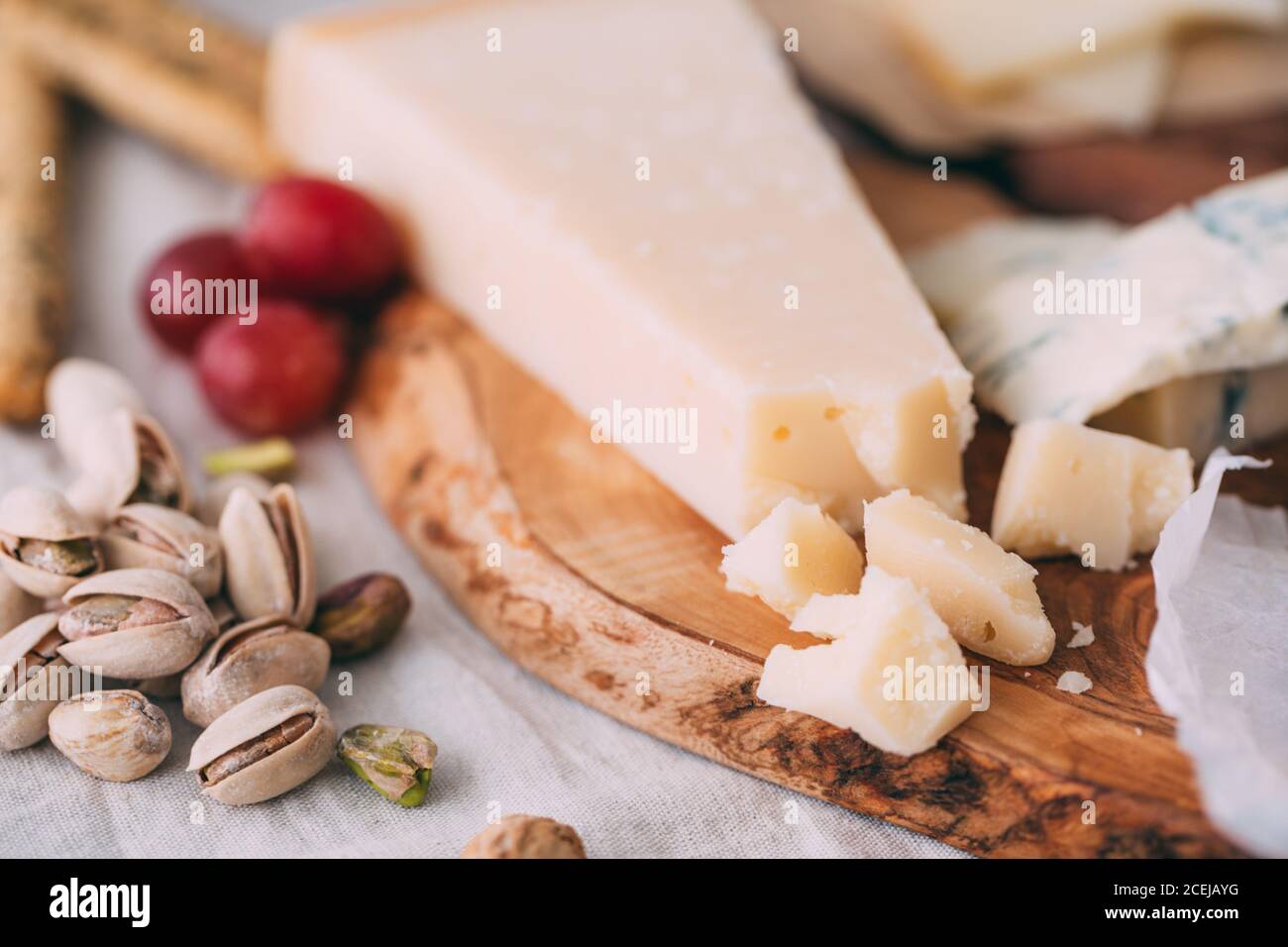 Cheese board with nuts, grapes and bread Stock Photo - Alamy