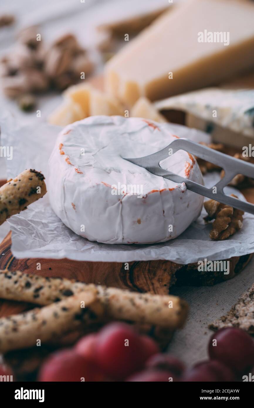 Cheese board with nuts, grapes and bread Stock Photo - Alamy