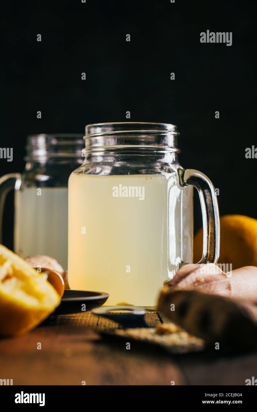 Preparing switchel with lemon juice, ginger and honey Stock Photo - Alamy