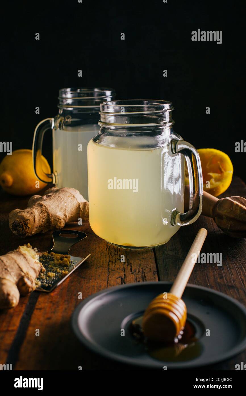 Preparing switchel with lemon juice, ginger and honey Stock Photo - Alamy