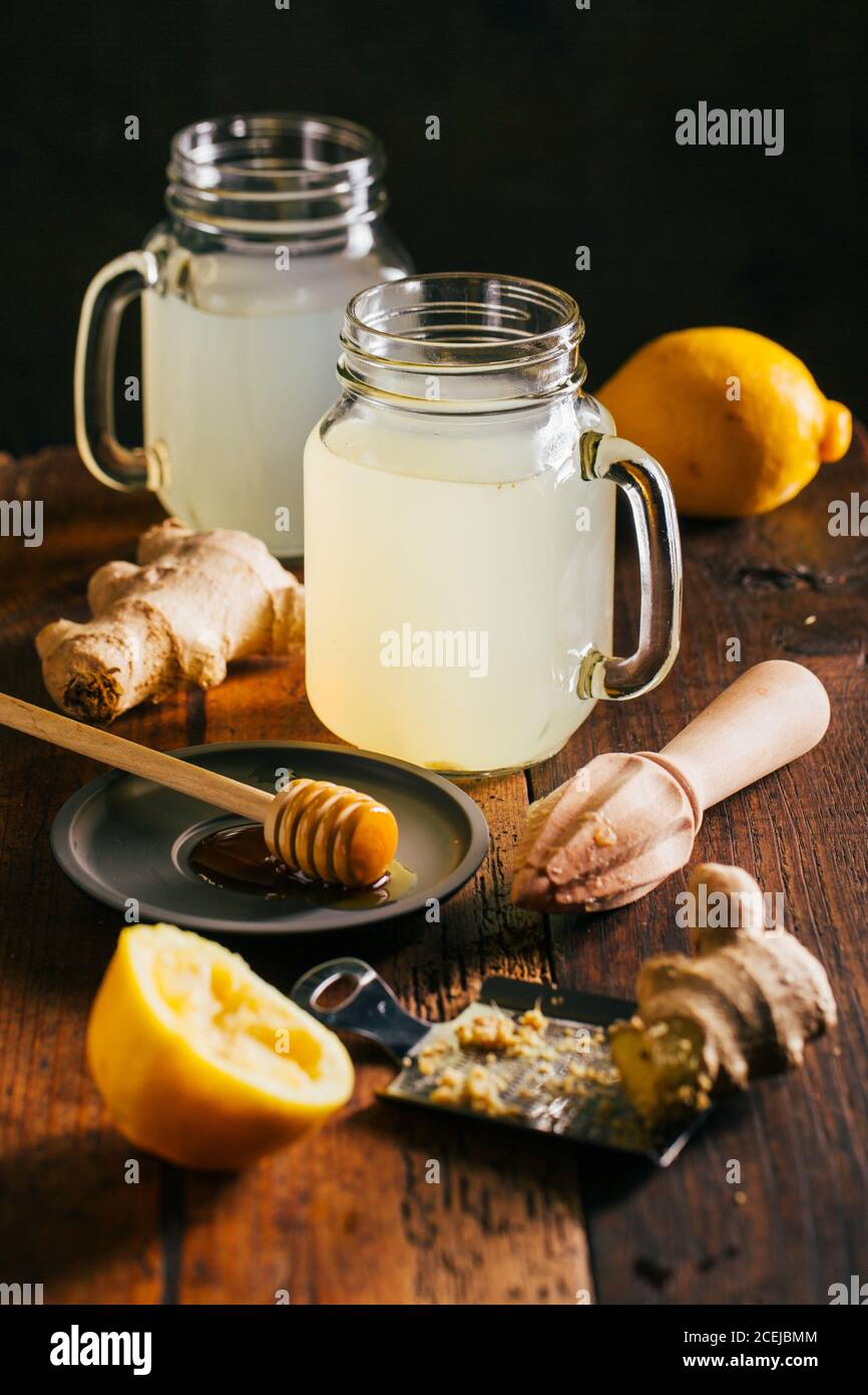 Preparing switchel with lemon juice, ginger and honey Stock Photo - Alamy