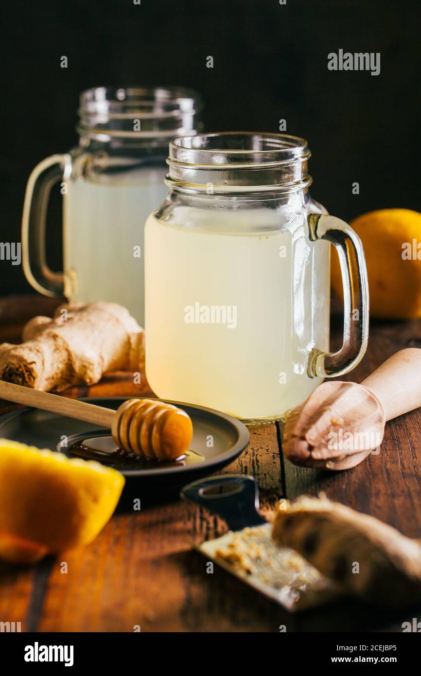 Preparing switchel with lemon juice, ginger and honey Stock Photo - Alamy