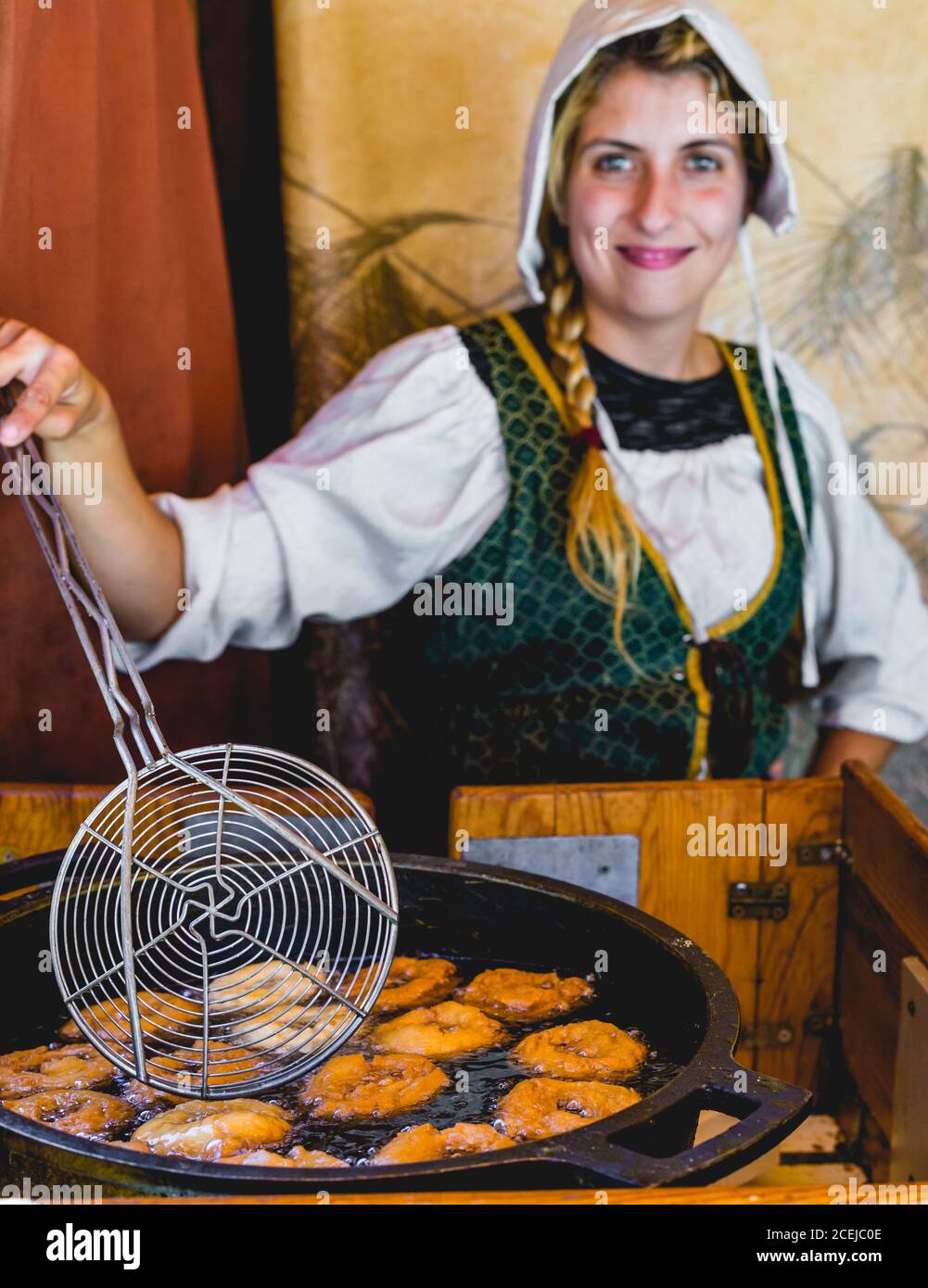 Woman in traditional costume cooking hi-res stock photography and ...