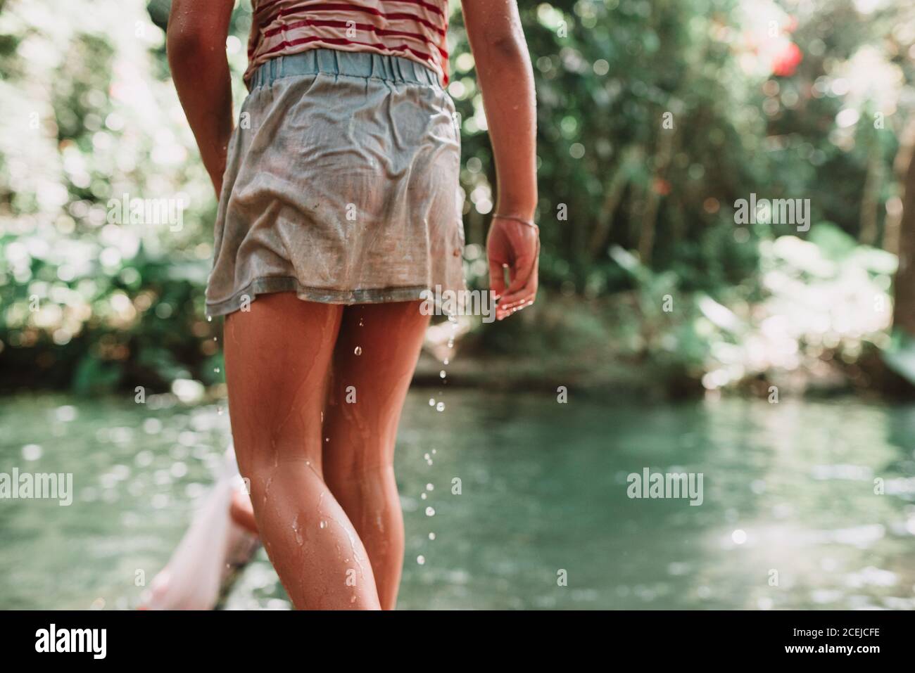 Back view of crop wet child standing at small pond in the forest Stock ...