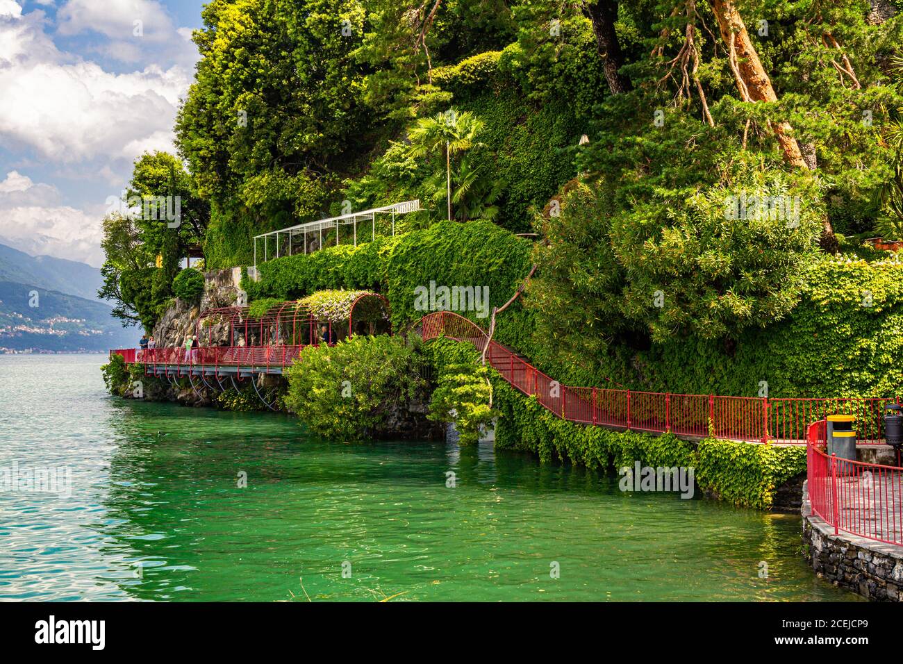 Red garden arch Walk of Lovers on coast leading towards the historic ...