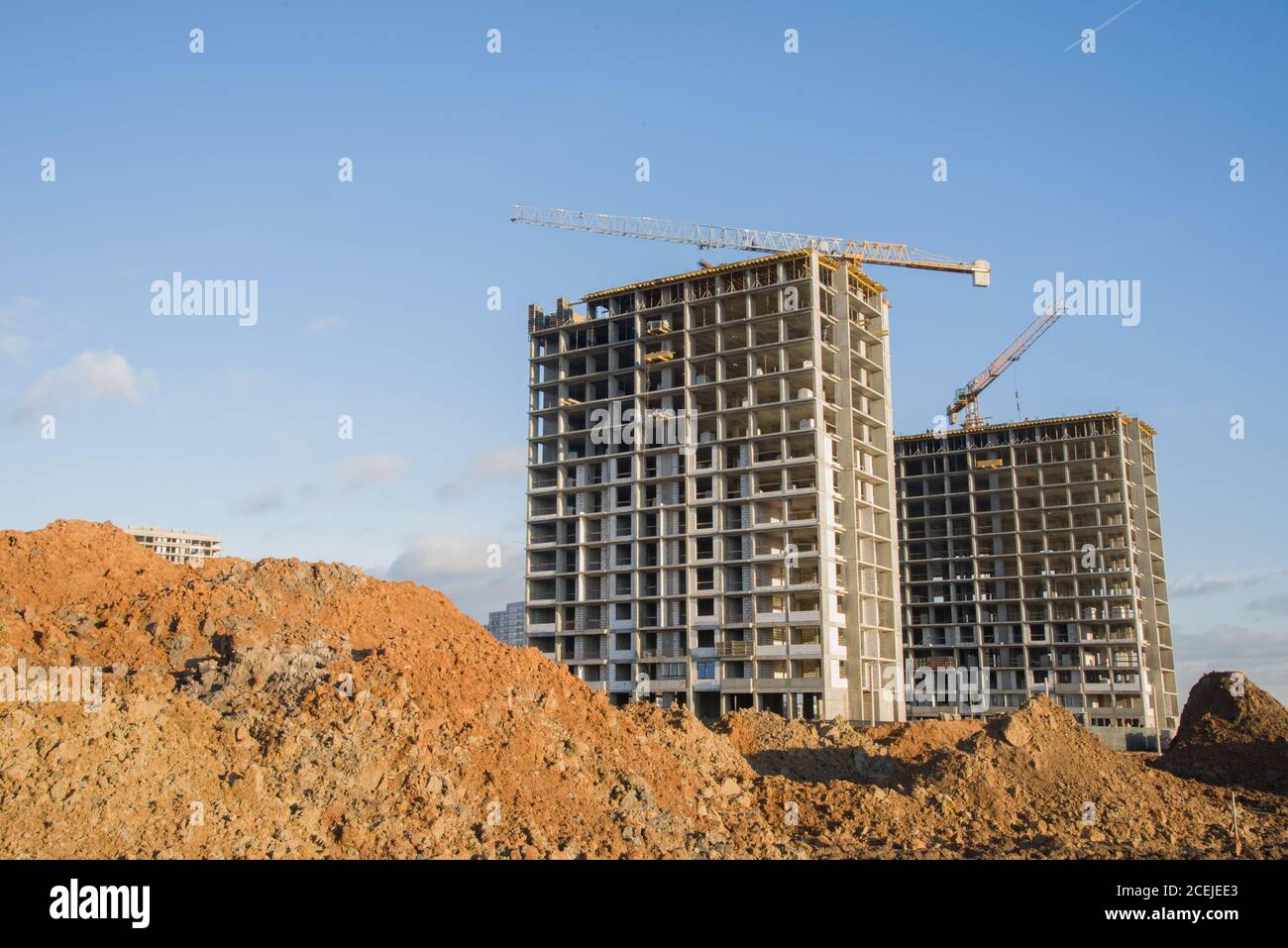 Hydraulic luffing jib tower cranes and workers being poured concrete ...