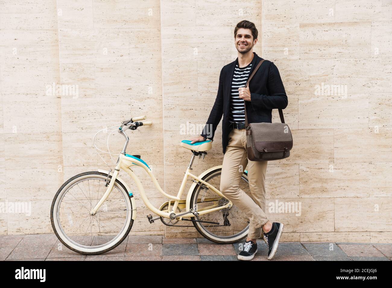 Image of a young positive handsome young business man outdoors on a ...