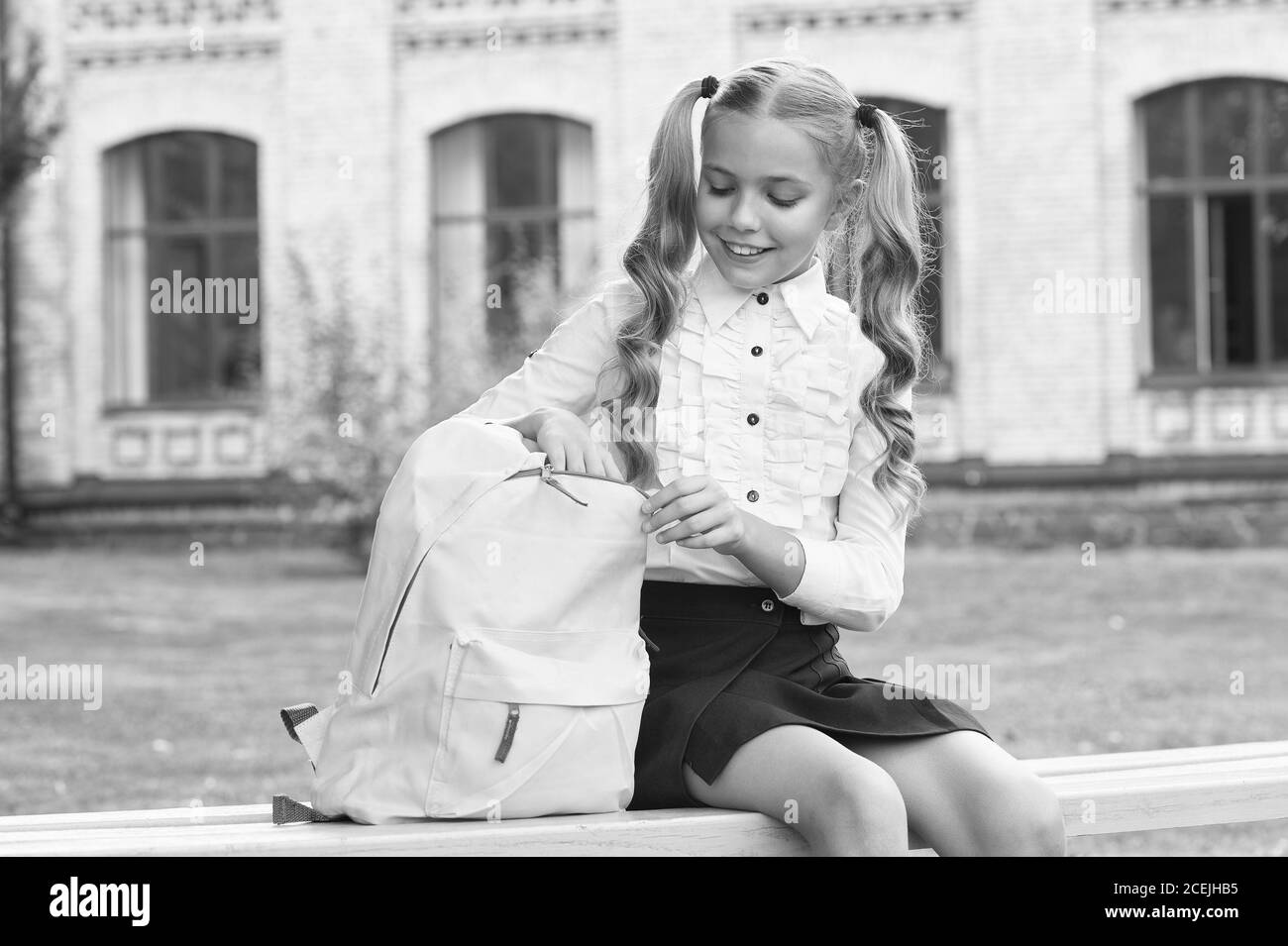 Doing homework outdoors. Small child do homework. Little girl open ...