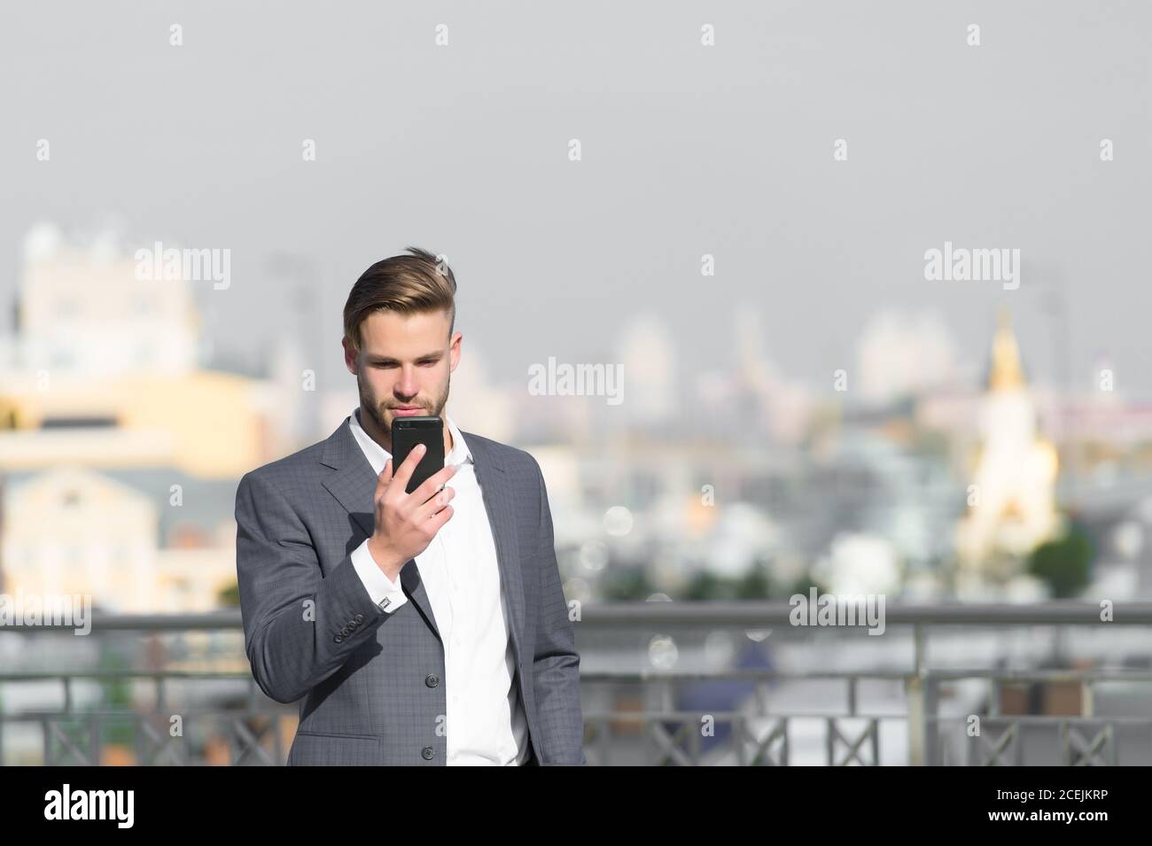 Businessman serious face received important message, skyline background ...