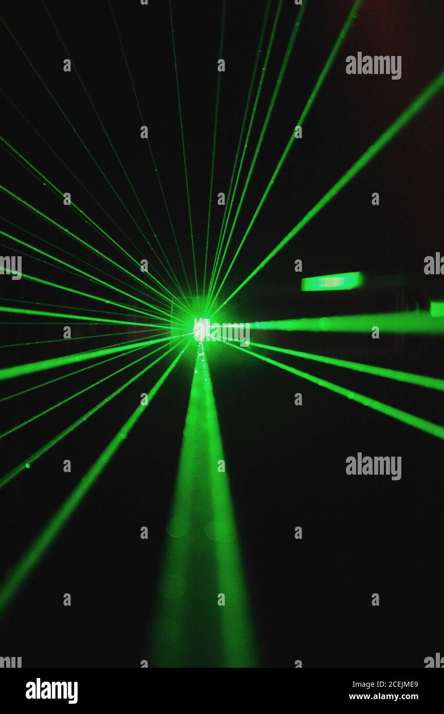 Rays of bright green light shining in dark room Stock Photo - Alamy