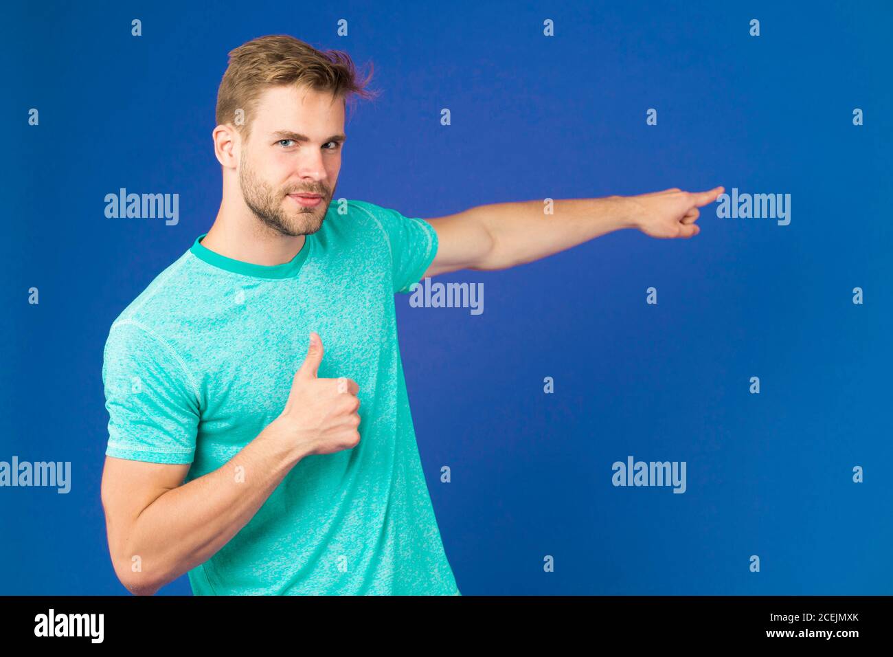 Highly recommend pointing at with index finger. Man unshaven face shows ...