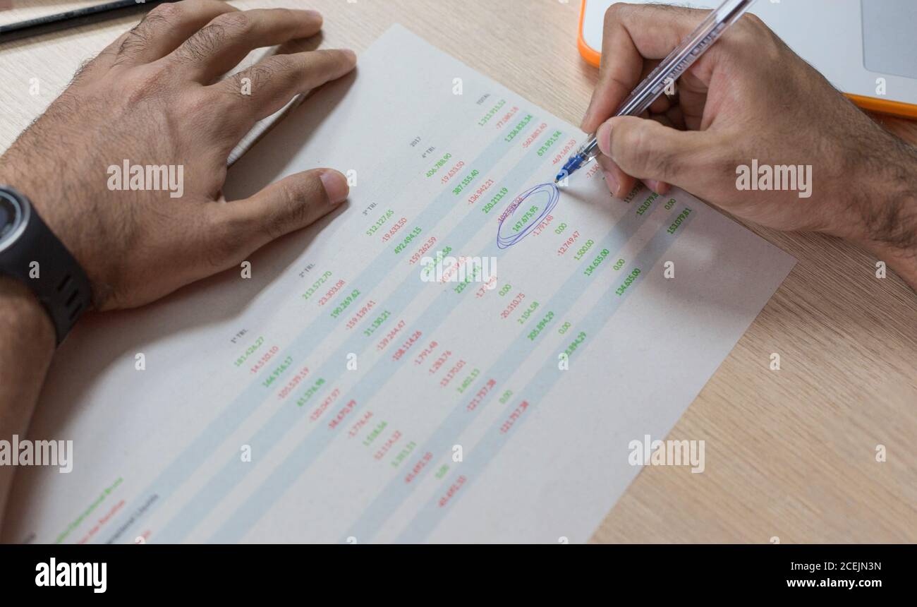 Focus on hands and financial control chart on office desk. Financial ...