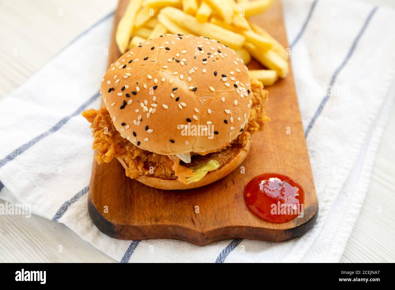 Homemade Chicken Strips Burger with French Fries and sour-sweet sauce ...