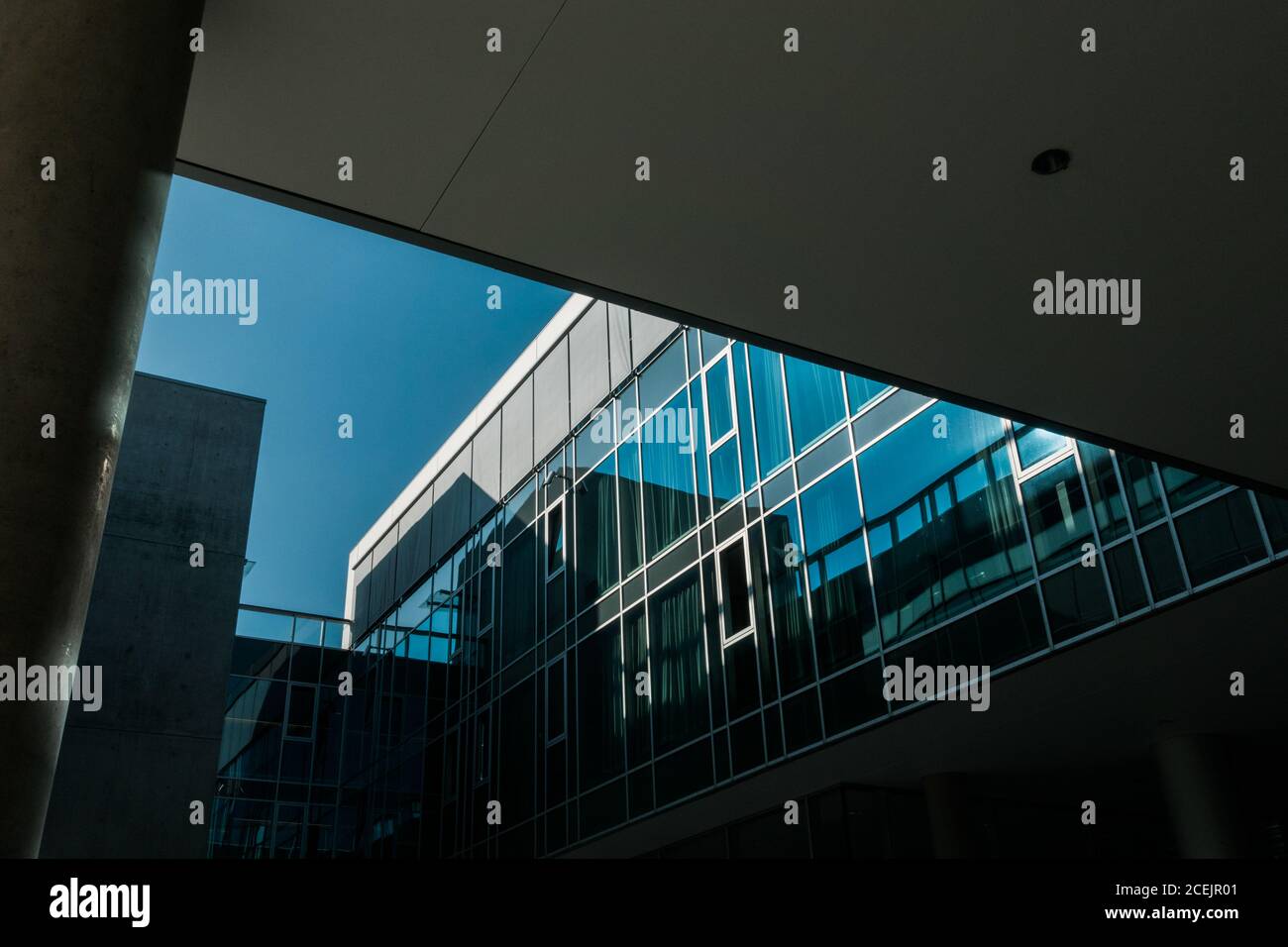 From below dark windows of modern?construction and blue sky Stock Photo ...