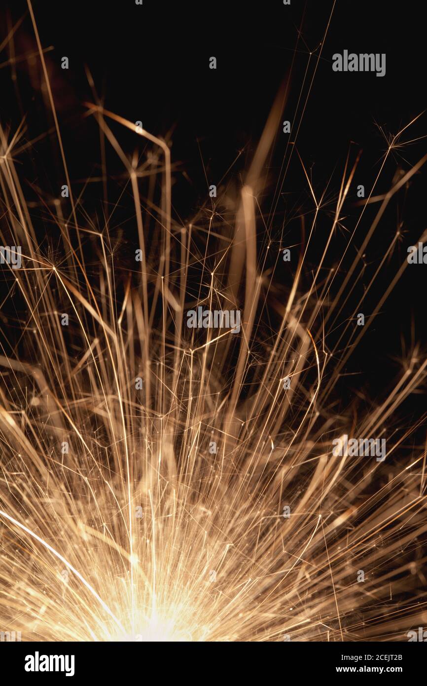 Closeup shot of beautiful sparkler burning and emitting bright sparks ...