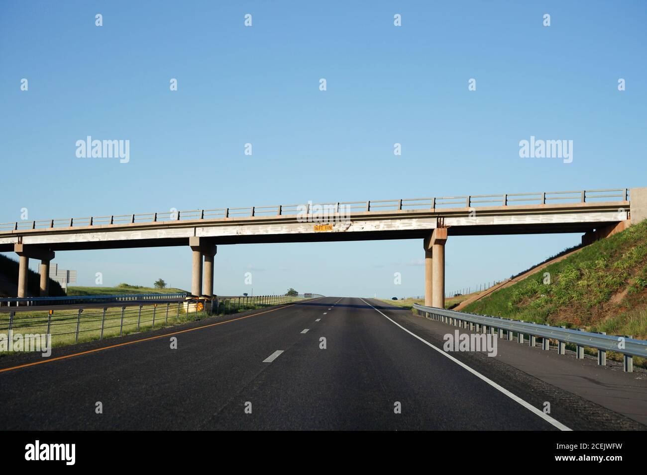 Bridge above road with height mentioned on board Stock Photo - Alamy