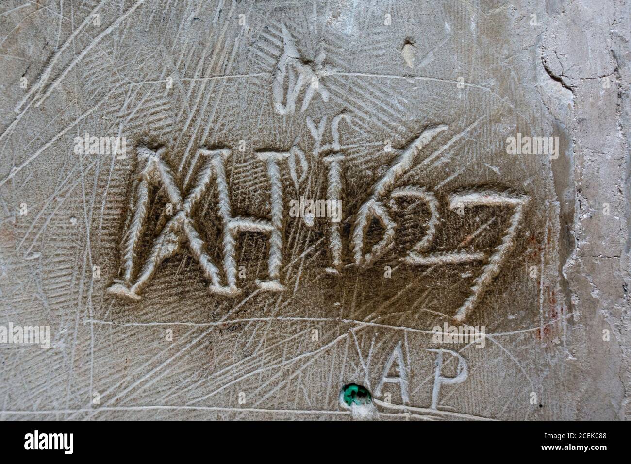 Close up of ancient graffiti in the stonework in St Albans Cathedral ...