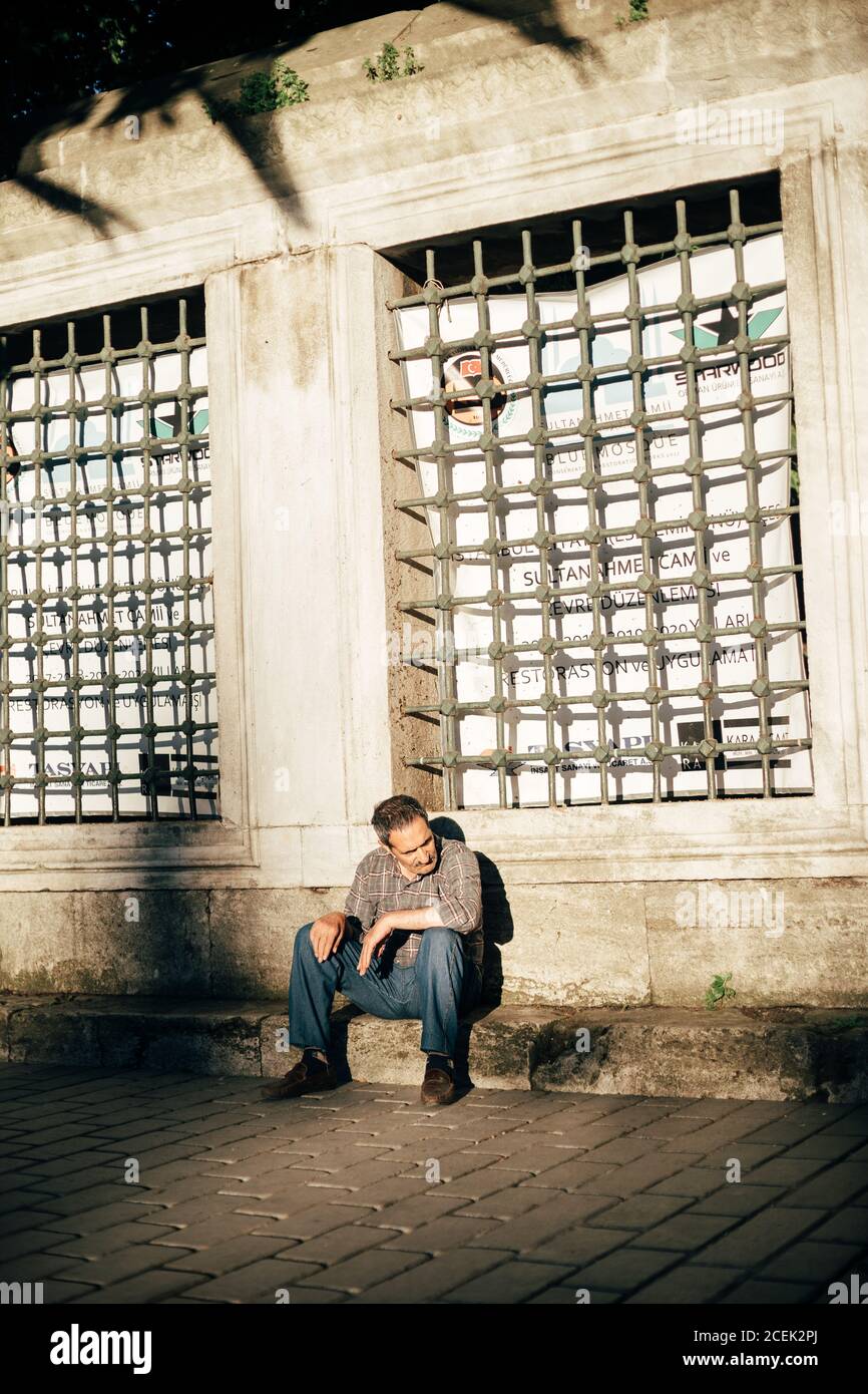 Istanbul, Turkey - August, 17 2018: Poor man leaning on wall Stock ...