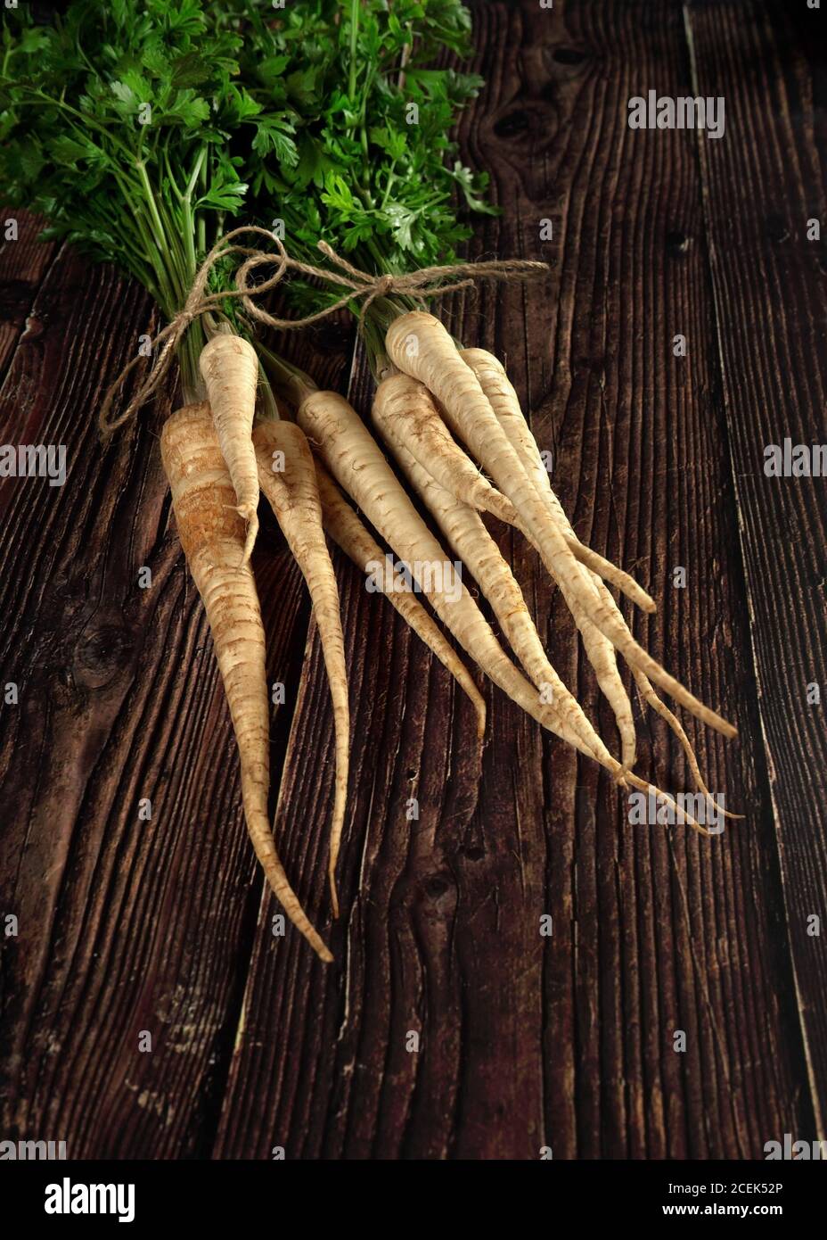 Bunch of parsley roots with green leaves on dark wooden board Stock ...