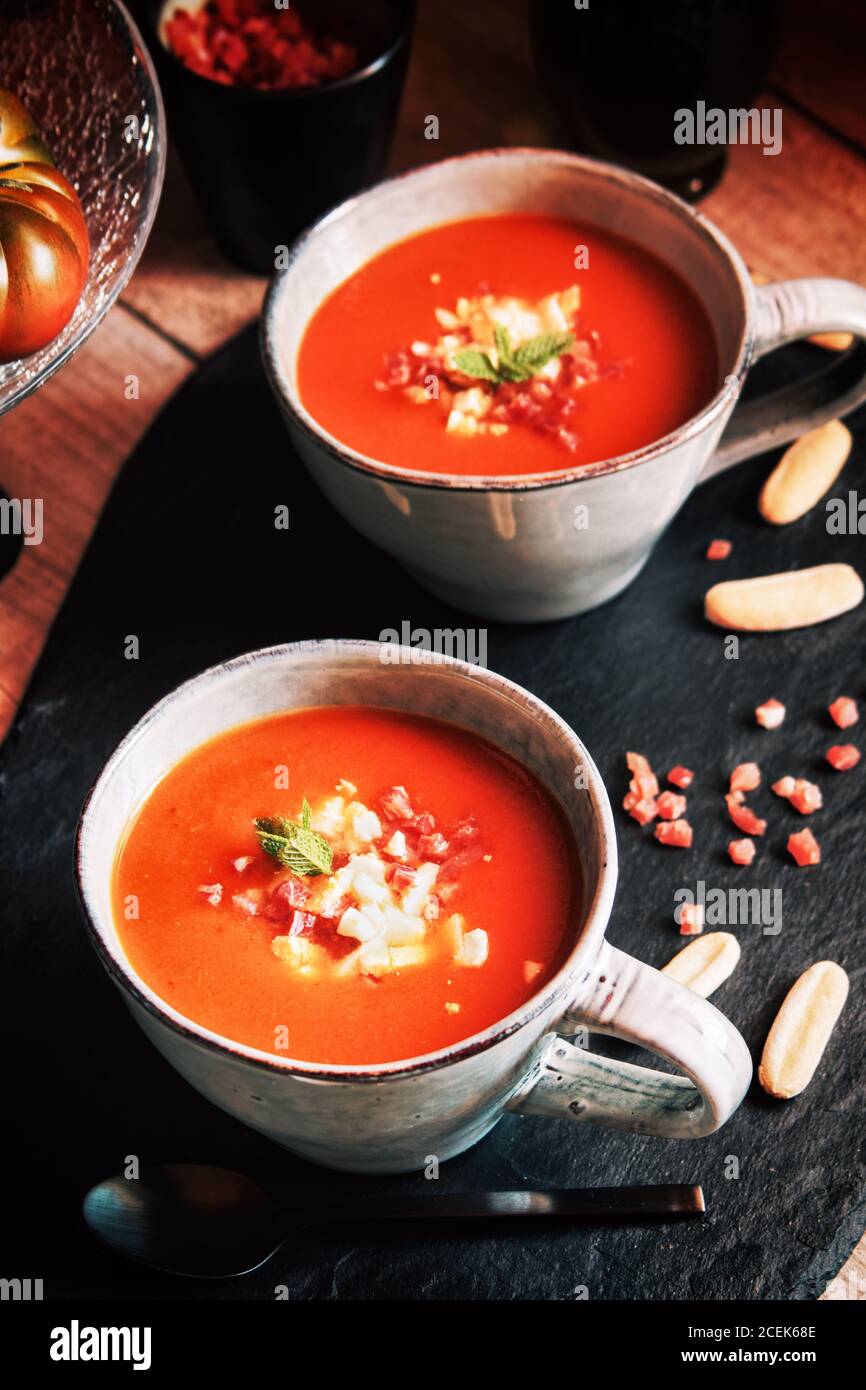Tomato gazpacho served with egg and ham in cups Stock Photo - Alamy
