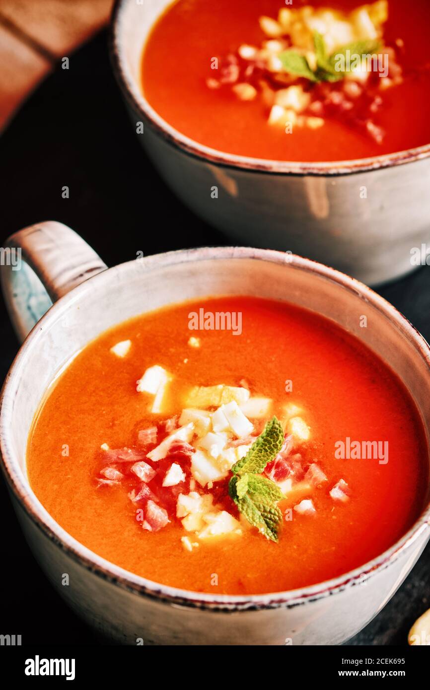 Tomato gazpacho served with egg and ham in cups Stock Photo - Alamy